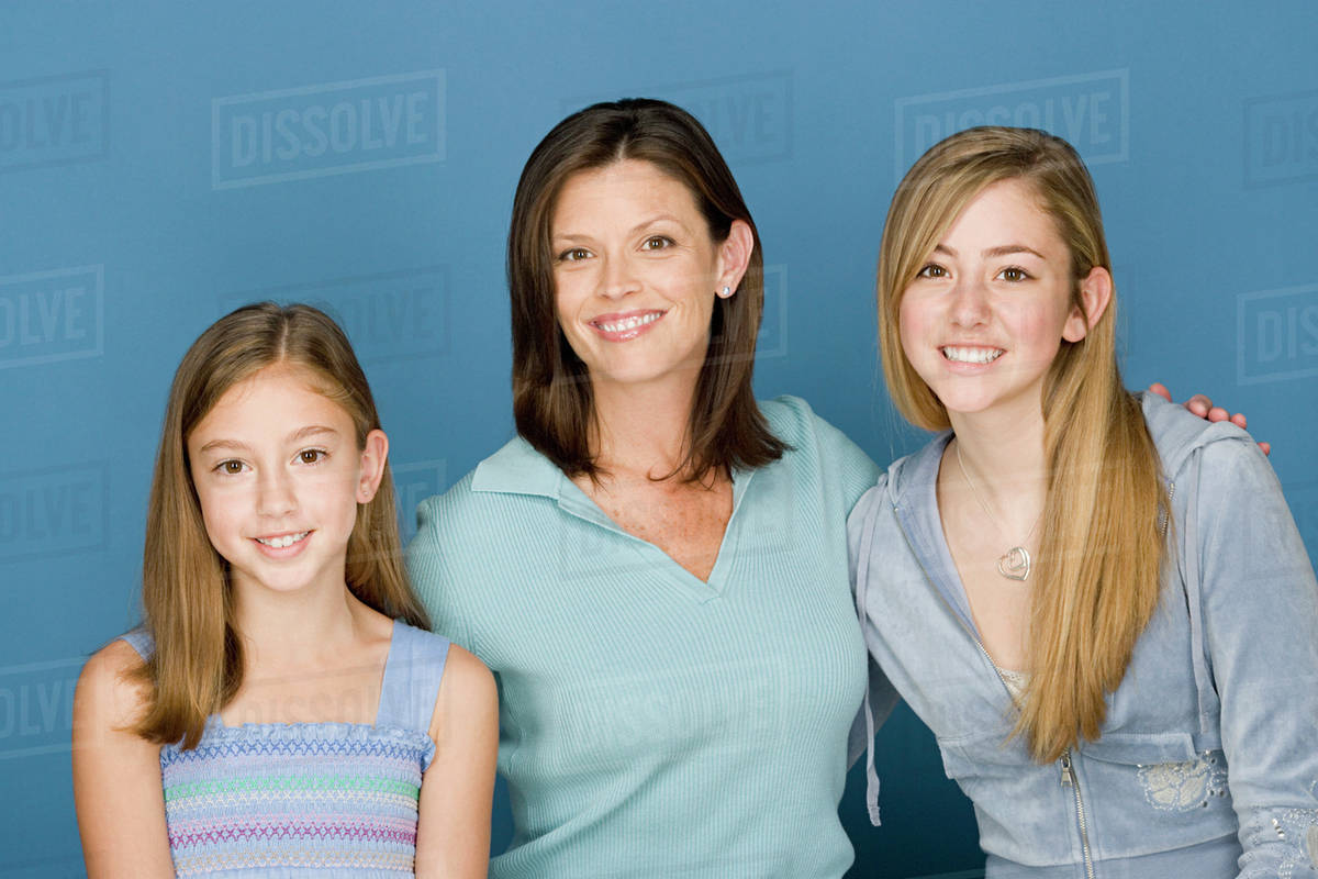 Portrait of mother with two daughters (8-9, 14-15) - Stock Photo - Dissolve