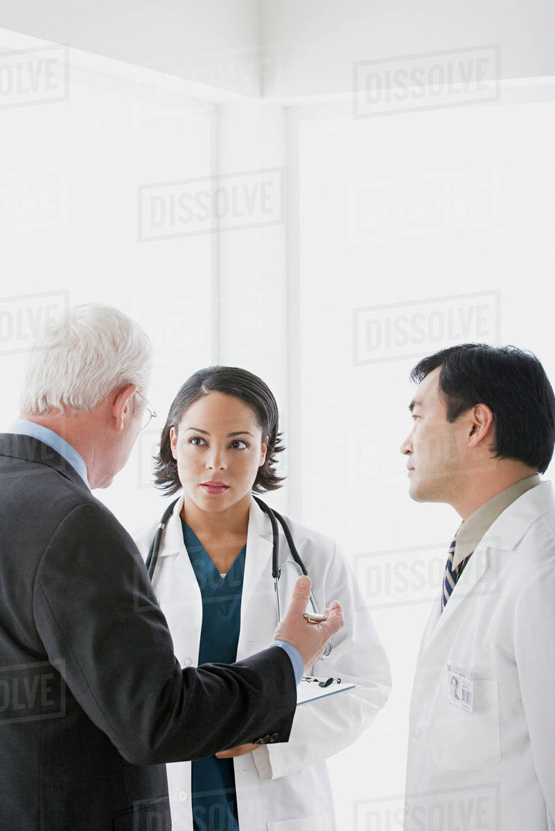Three doctors in discussion - Royalty-free Stock Photo | Dissolve