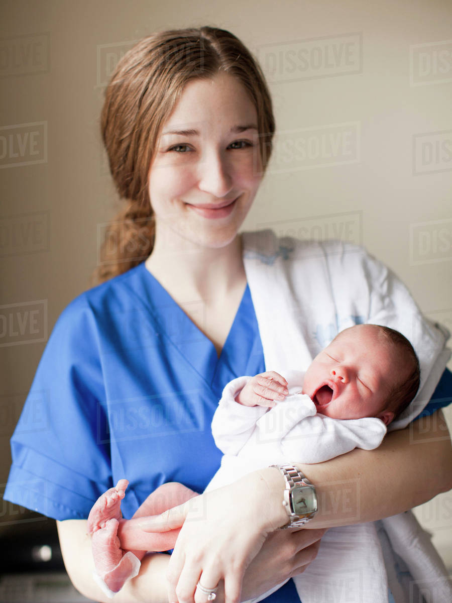Portrait of young female nurse holding baby boy (2-5 months) - Royalty ...