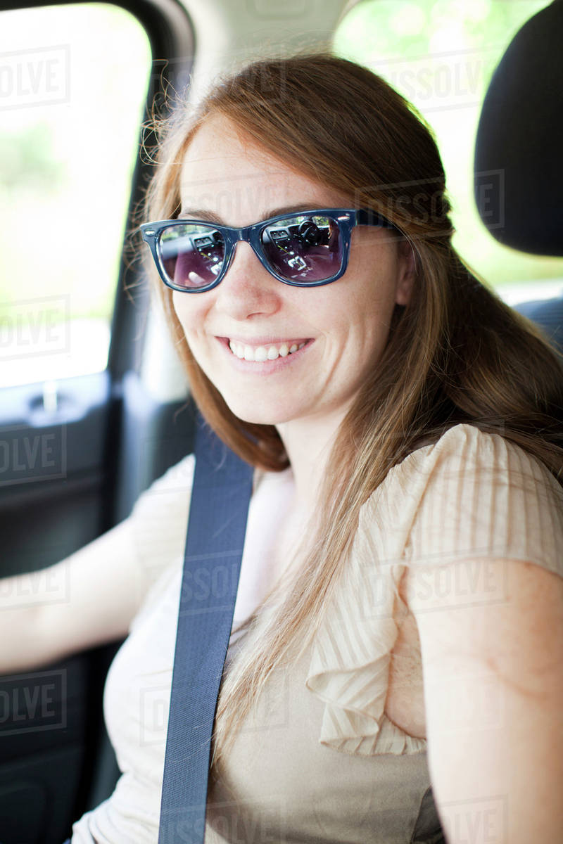 Portrait of young woman in car - Royalty-free Stock Photo | Dissolve