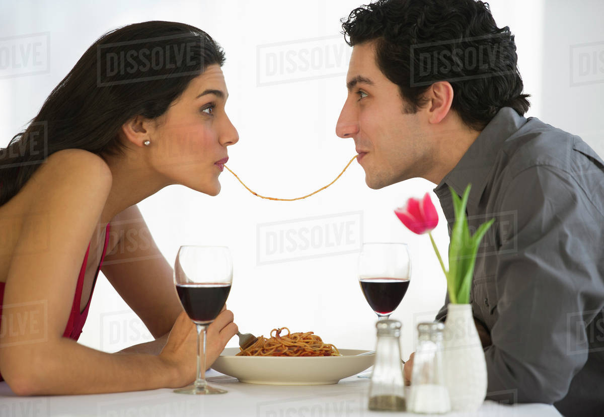 Happy couple eating spaghetti together - Royalty-free Stock Photo ...