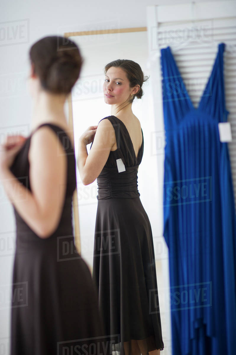 Woman fitting new dress - Stock Photo - Dissolve