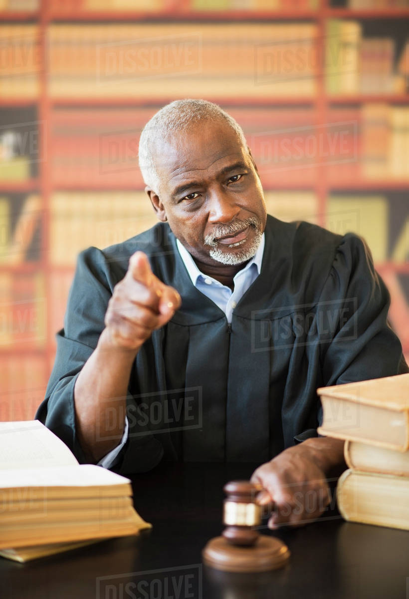 Judge holding gavel in courtroom and pointing - Royalty-free Stock ...