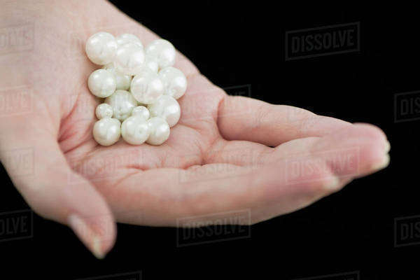 Woman holding pearls - Royalty-free Stock Photo | Dissolve