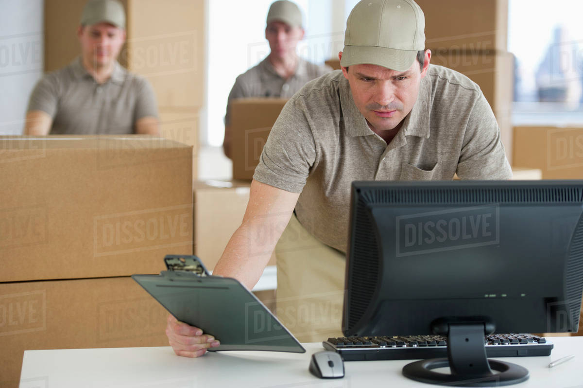 USA, New Jersey, Jersey City, man checking checklist in warehouse ...