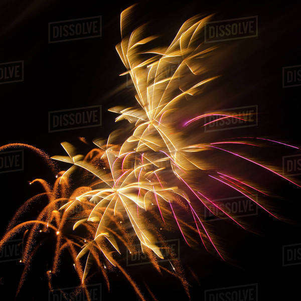 Fireworks explosion against night sky - Royalty-free Stock Photo | Dissolve