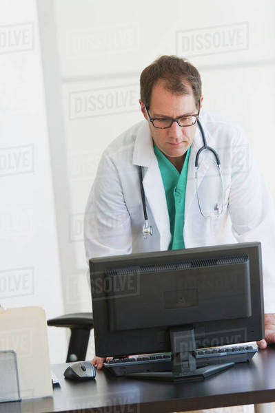 Doctor using computer - Stock Photo - Dissolve