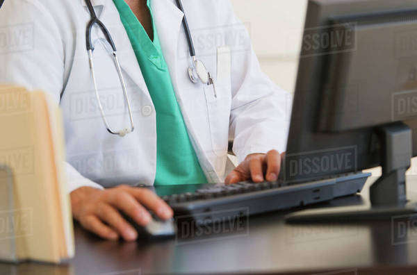 Doctor using computer - Royalty-free Stock Photo | Dissolve