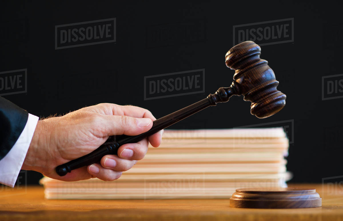 Judge holding gavel, close-up - Royalty-free Stock Photo | Dissolve