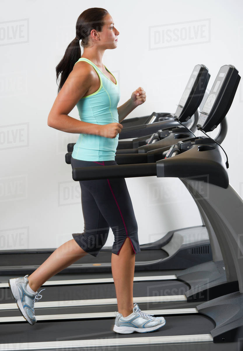 Woman walking on treadmill - Royalty-free Stock Photo | Dissolve