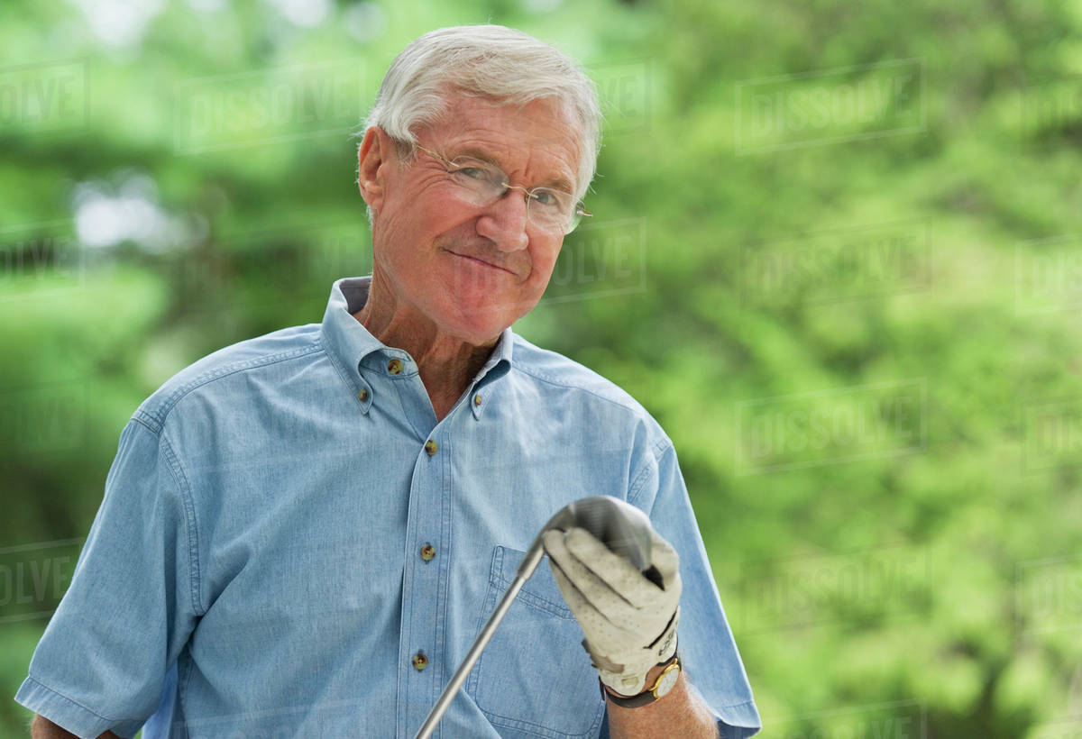 Senior man holding golf club, portrait - Royalty-free Stock Photo ...