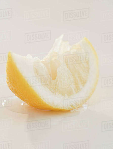 Close up of slice of lemon - Royalty-free Stock Photo | Dissolve