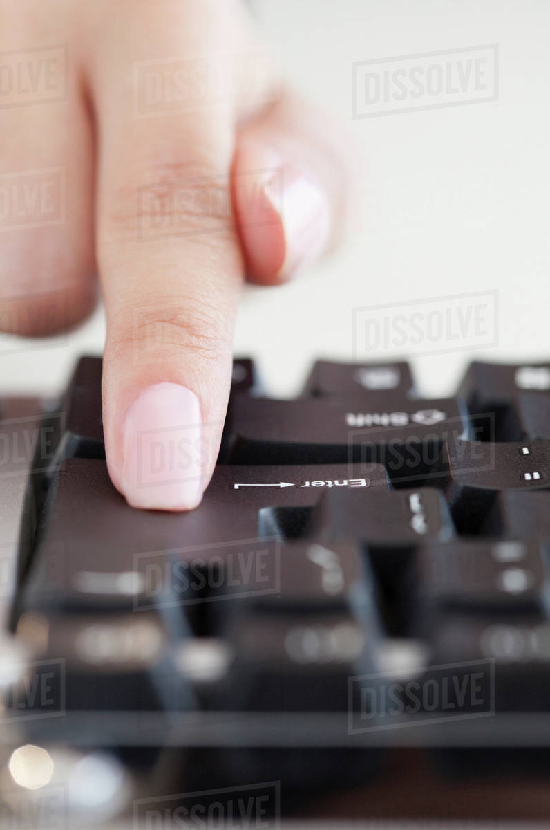 Close up of woman's hand pressing enter key - Royalty-free Stock Photo ...