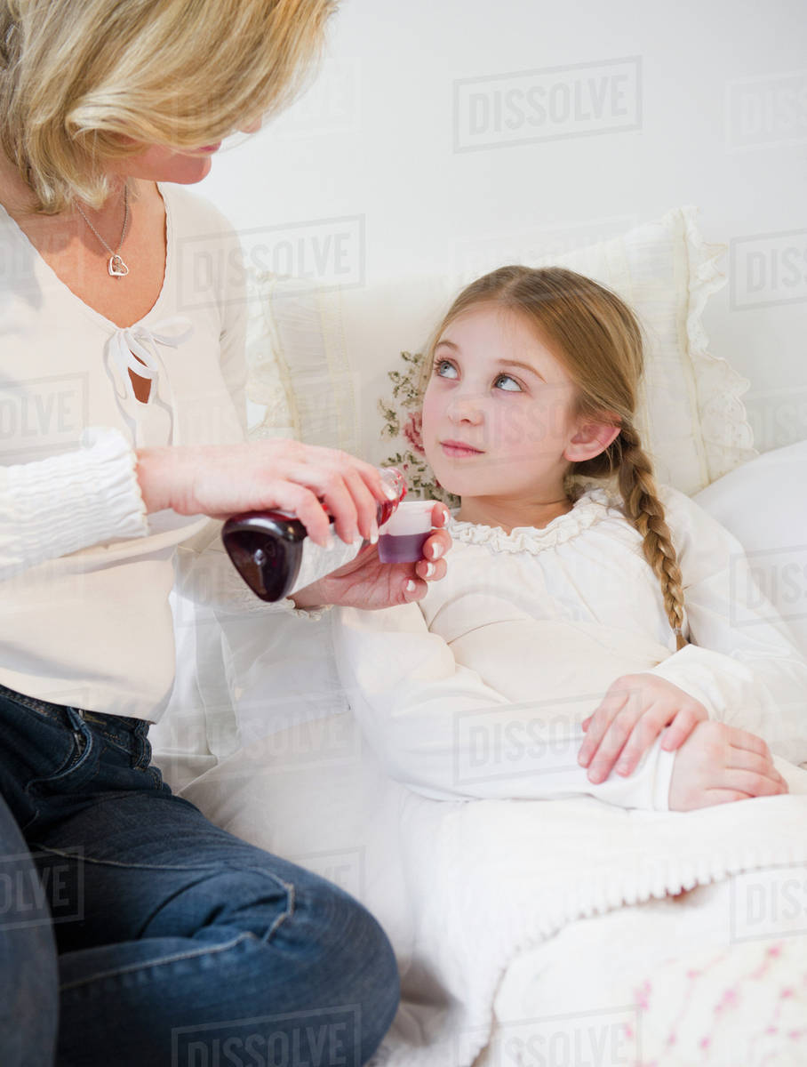USA, Jersey City, New Jersey, mother giving medication to daughter (10 ...
