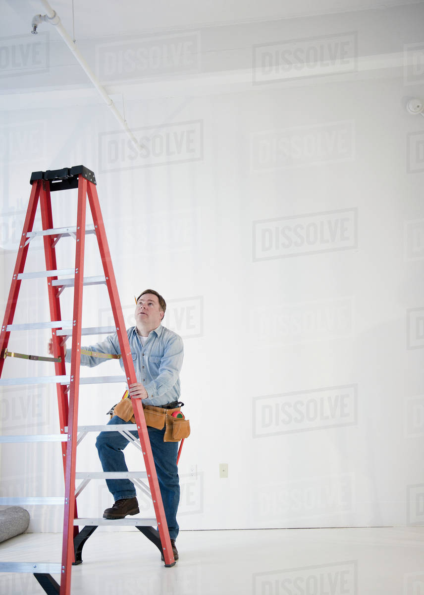 USA, Jersey City, New Jersey, worker climbing ladder - Stock Photo ...