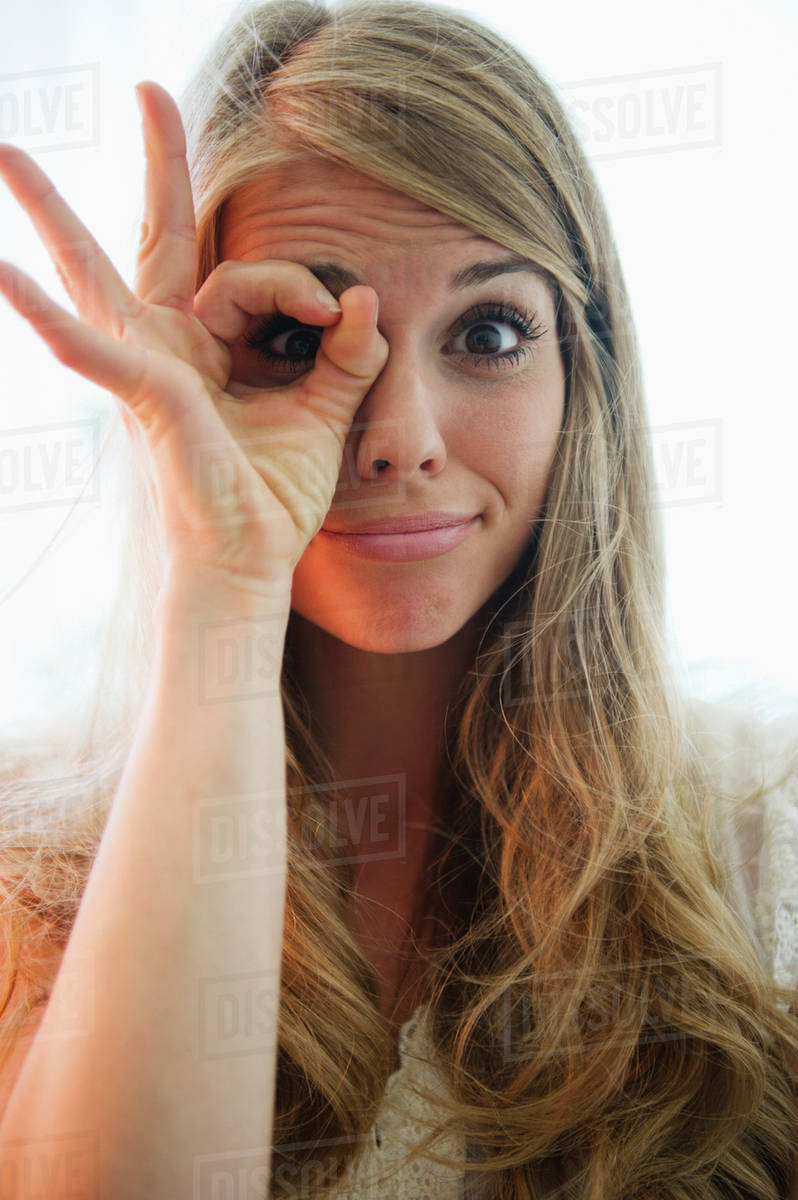 Portrait of blonde woman showing ok sign - Royalty-free Stock Photo ...