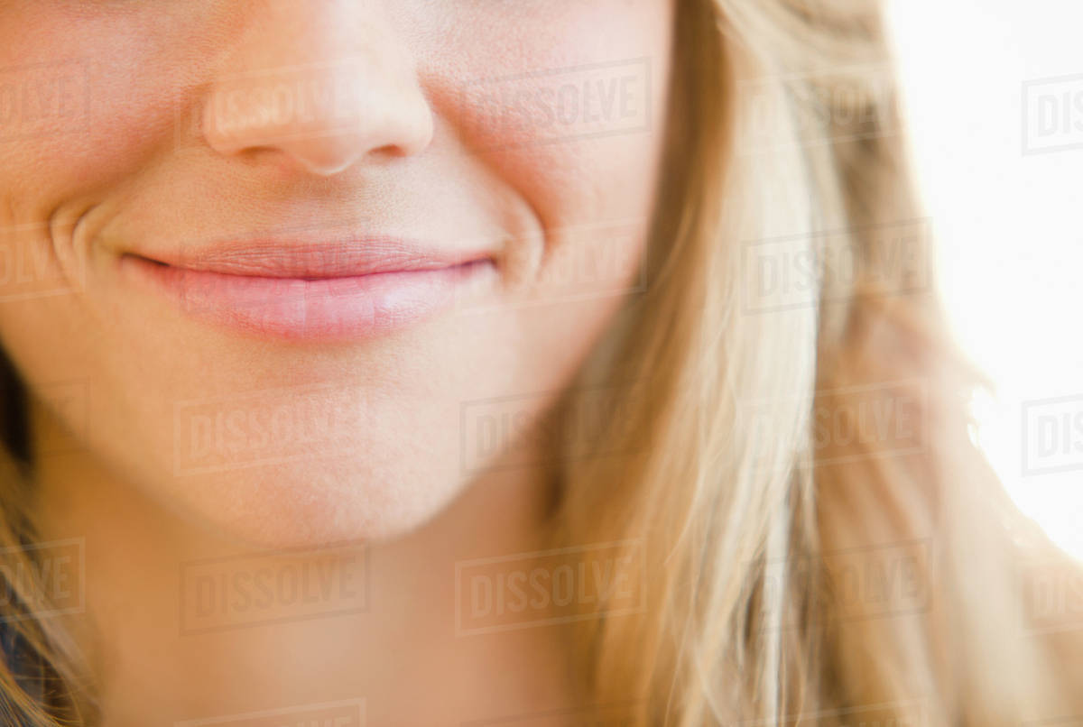 Close up of mouth of smirking woman - Royalty-free Stock Photo | Dissolve