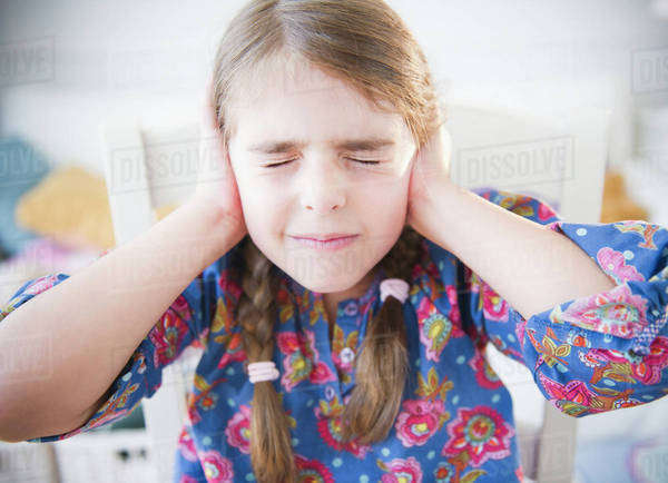 Girl ( 6-7) covering ears - Stock Photo - Dissolve