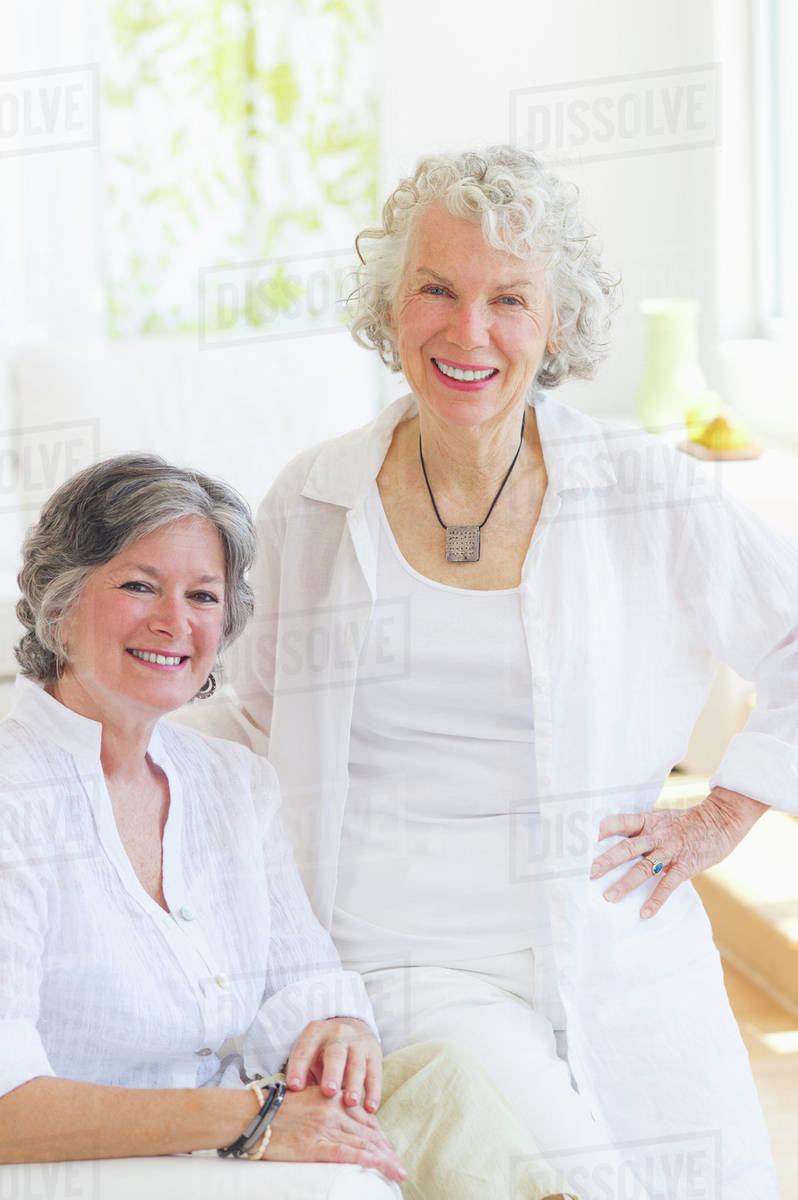 Two senior women in living room - Stock Photo - Dissolve