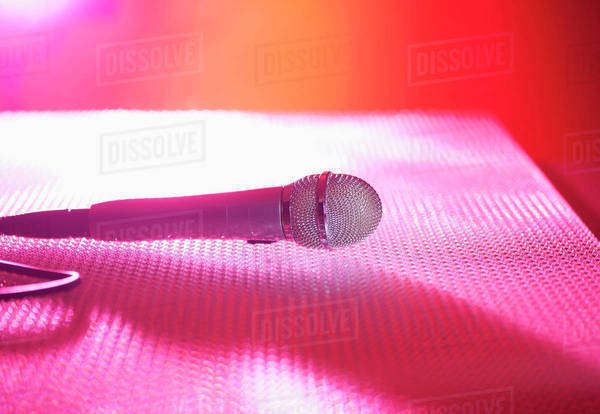 Close up of microphone lying on stage - Royalty-free Stock Photo | Dissolve