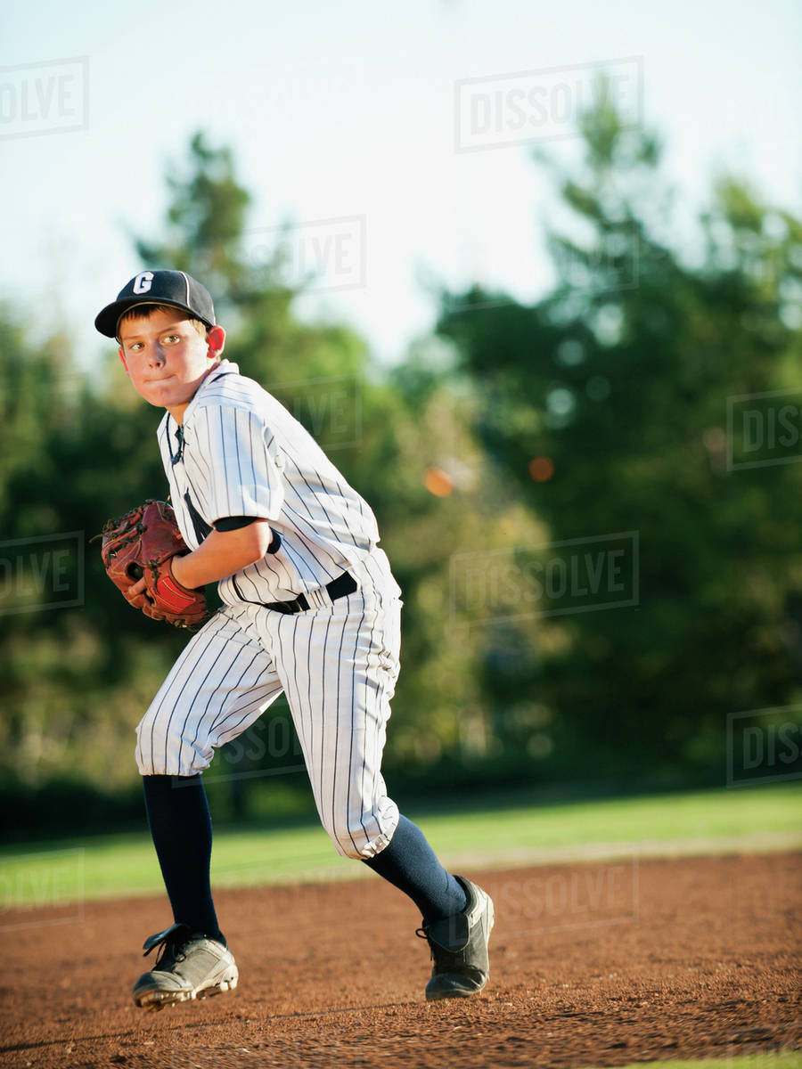 Boy (10-11) playing baseball - Royalty-free Stock Photo | Dissolve