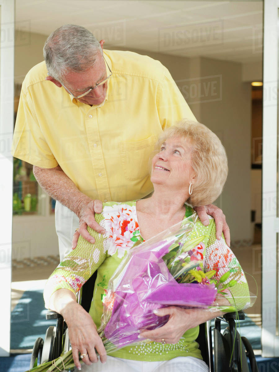Senior people going out from hospital - Stock Photo - Dissolve