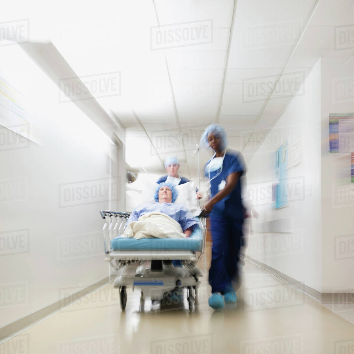Senior woman being taken to operating room by medical staff - Royalty ...
