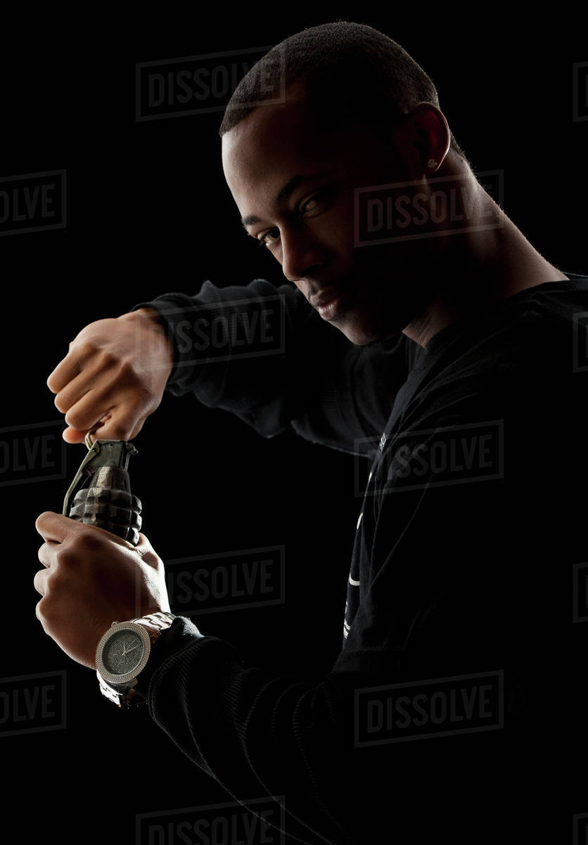 Studio portrait of young man holding grenade - Royalty-free Stock Photo ...