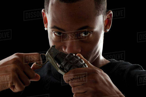Studio portrait of young man holding grenade - Royalty-free Stock Photo ...