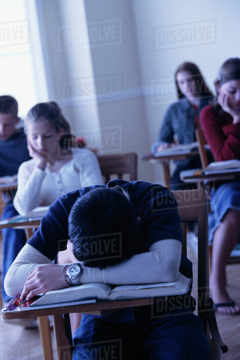 Student with head on desk - Royalty-free Stock Photo | Dissolve