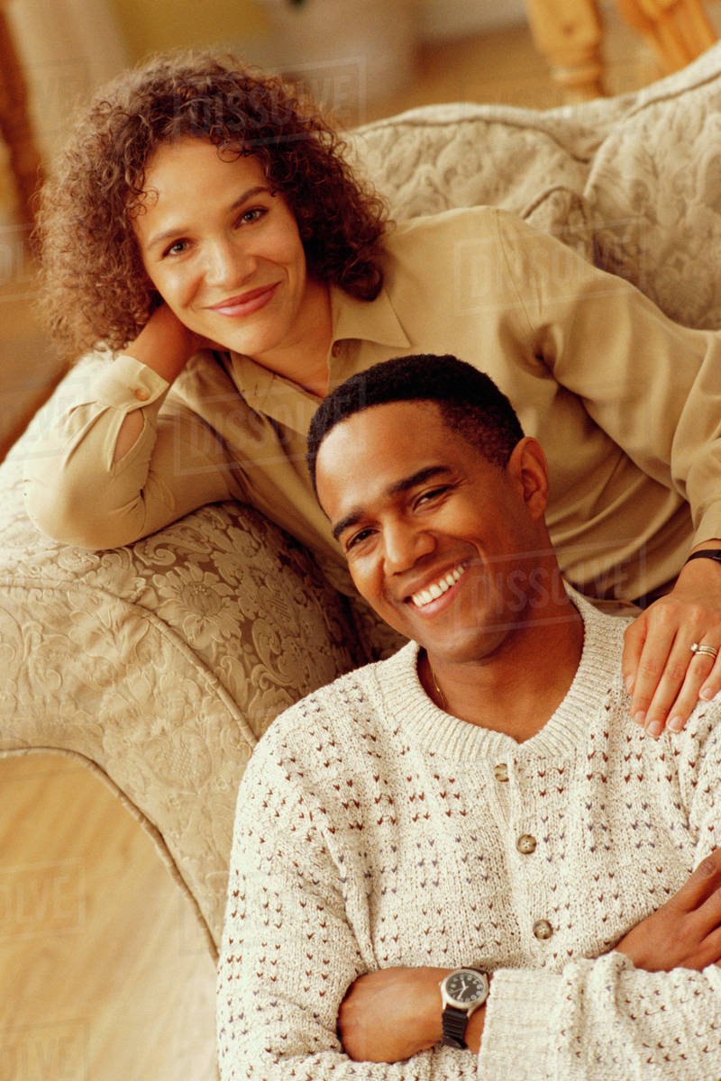 Couple sitting together at home - Royalty-free Stock Photo | Dissolve