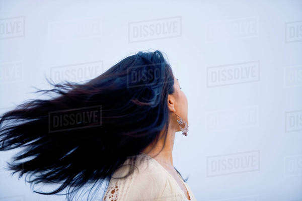 Windswept young woman - Stock Photo - Dissolve