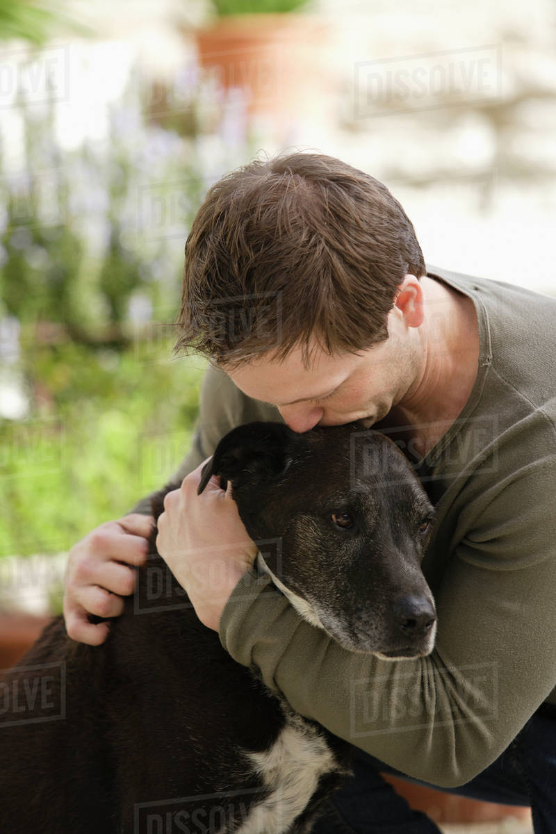 Man hugging dog - Royalty-free Stock Photo | Dissolve