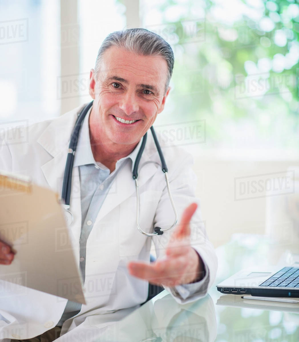Portrait of doctor in his office - Stock Photo - Dissolve