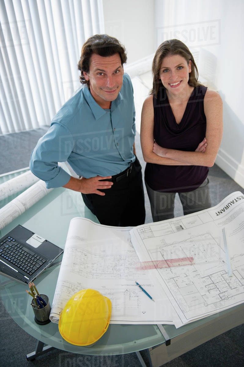 Architects with blueprints in office - Royalty-free Stock Photo | Dissolve