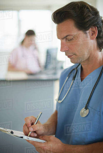 Doctor writing documentation in hospital - Royalty-free Stock Photo ...