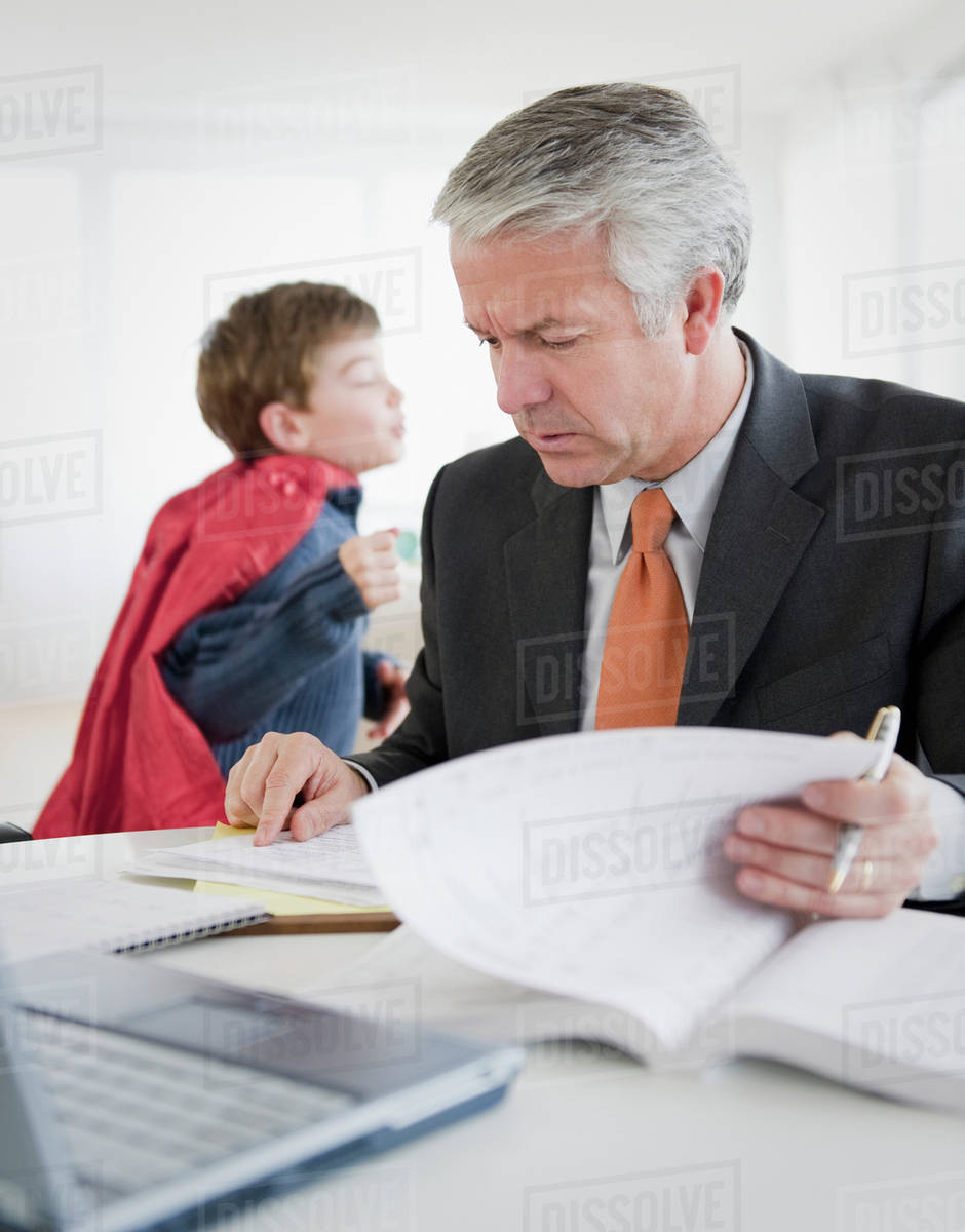 Father working at home - Stock Photo - Dissolve