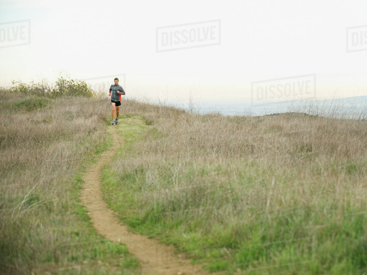 Person running on trail - Stock Photo - Dissolve