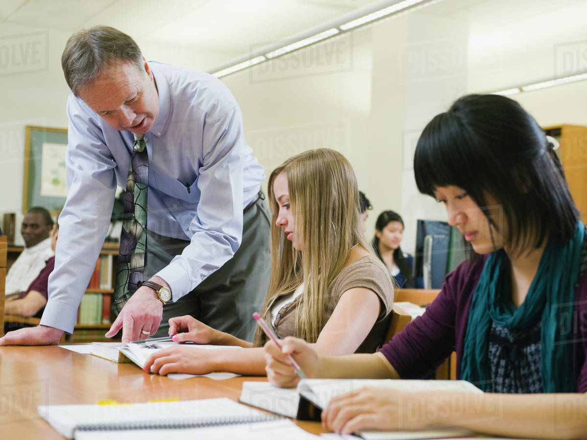 Professor giving instruction to college student - Royalty-free Stock ...