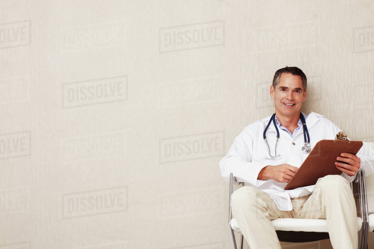 Doctor sitting in waiting room - Royalty-free Stock Photo | Dissolve