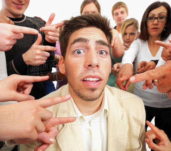 Group of people pointing at one person - Stock Photo - Dissolve