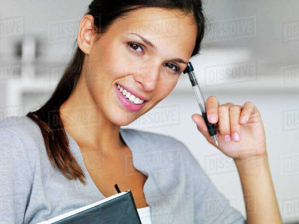 Woman writing in notebook - Royalty-free Stock Photo | Dissolve