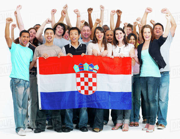 Group of people holding flag - Stock Photo - Dissolve