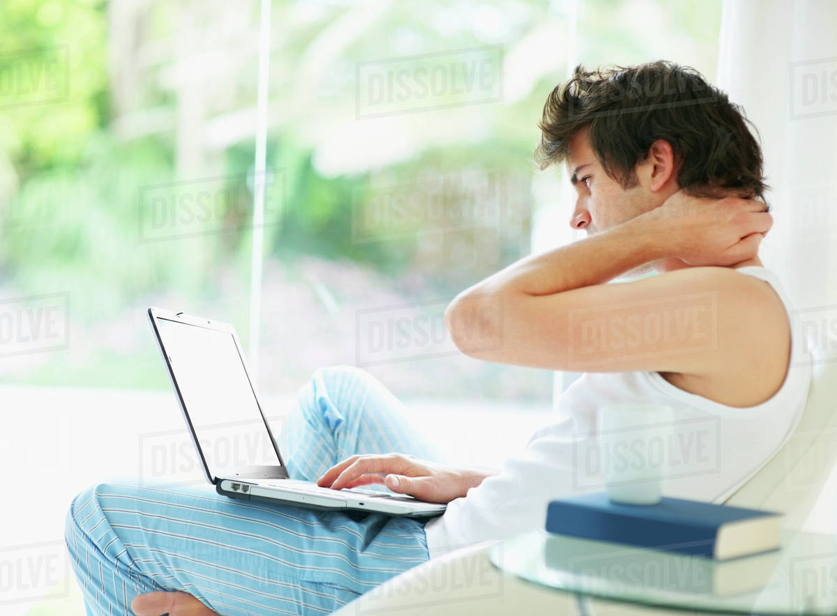 Relaxed man browsing the internet - Royalty-free Stock Photo | Dissolve