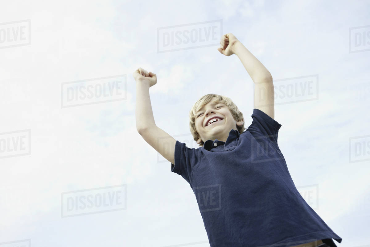 Happy young boy raising his arms in the air - Royalty-free Stock Photo ...