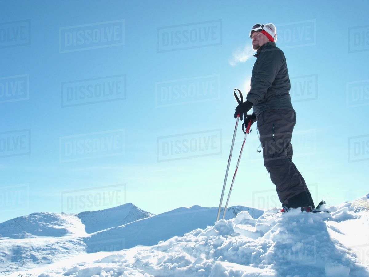 Male skier standing on mountain - Royalty-free Stock Photo | Dissolve