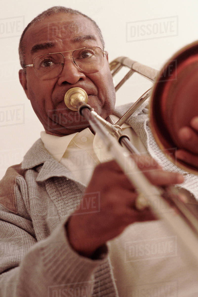 Man playing the trombone - Stock Photo - Dissolve