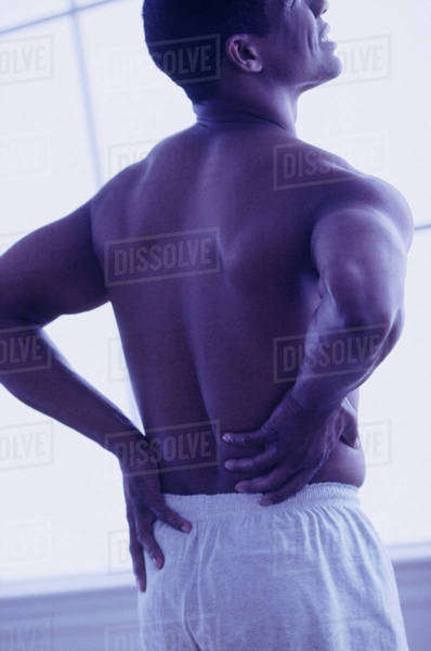 Man with a strained back - Stock Photo - Dissolve