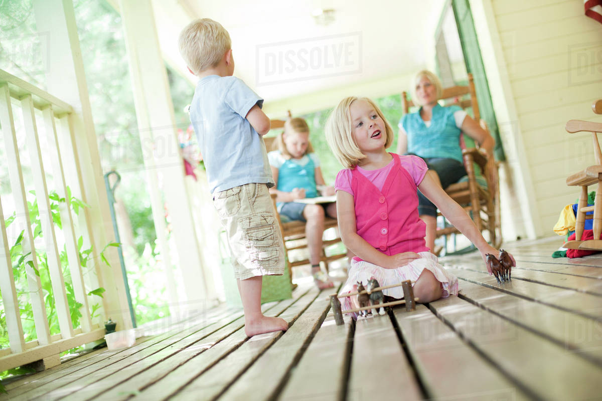 Children playing on porch - Royalty-free Stock Photo | Dissolve