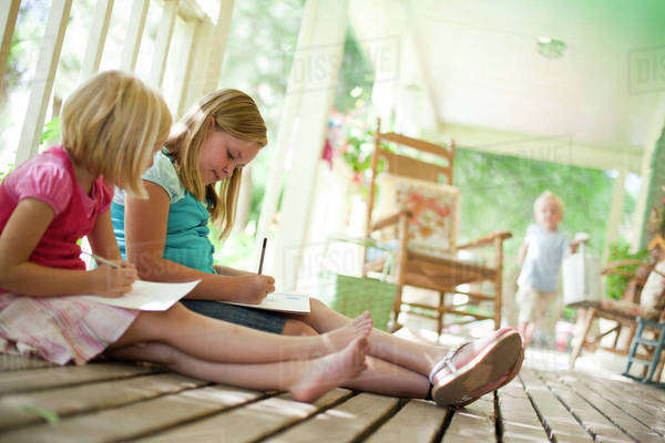 Two girls writing letters - Royalty-free Stock Photo | Dissolve